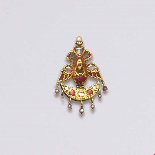 A delicate diamond and ruby bird pendant | Christie's