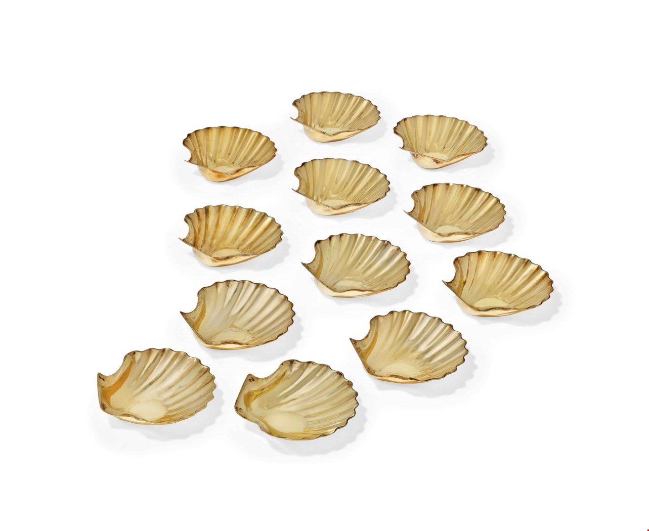 A SET OF TWELVE FRENCH EMPIRE SILVER-GILT BUTTER-SHELLS , MARK OF JEAN ...