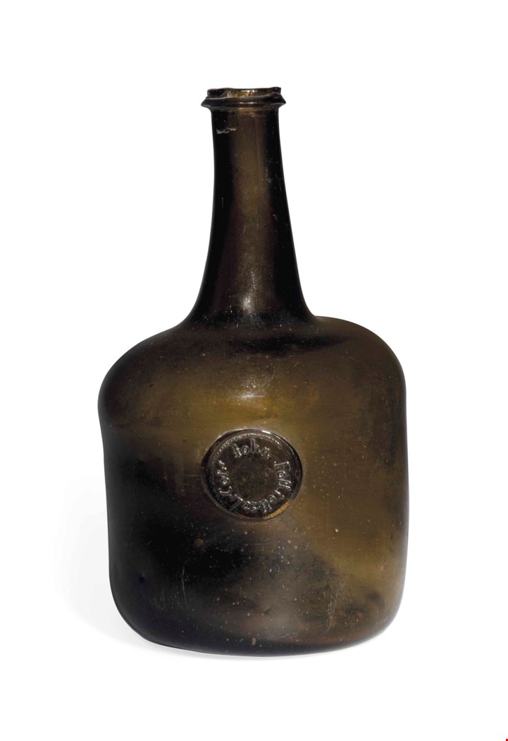 AN ENGLISH GLASS SEALED WINE BOTTLE , DATED 1743 | Christie's