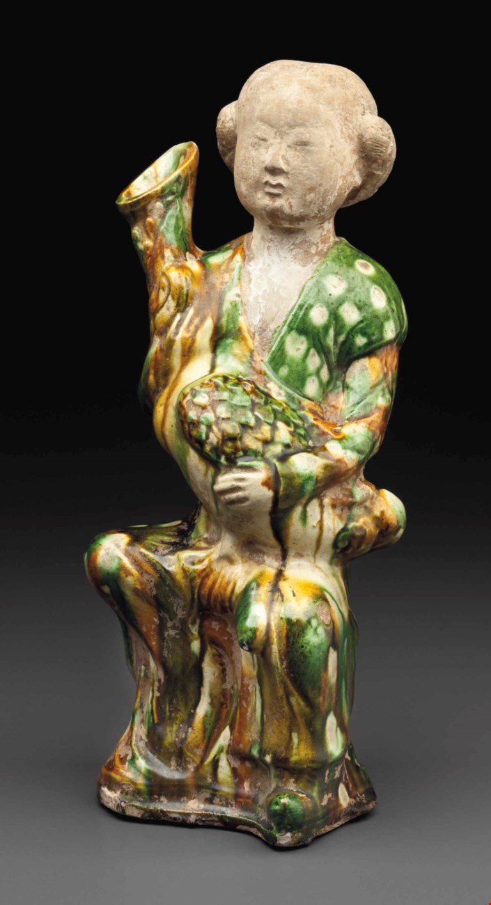 A SANCAI-GLAZED POTTERY FIGURE OF A WOMAN HOLDING A GOOSE, TANG DYNASTY ...