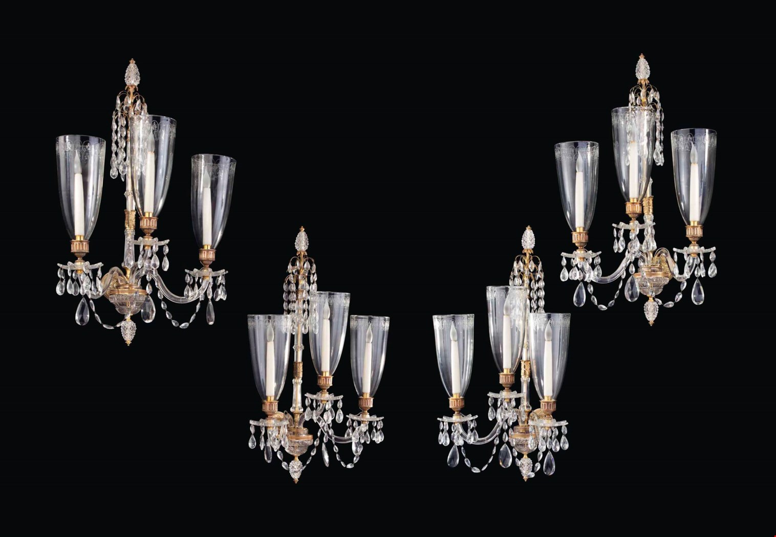 A SET OF FOUR GEORGE III CUT-GLASS AND ORMOLU THREE-BRANCH WALL LIGHTS ...