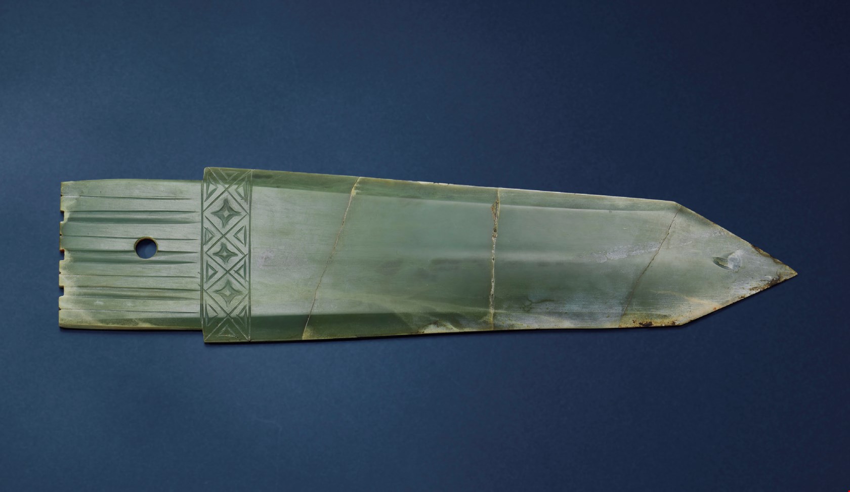 A LARGE GREEN AND RUSSET JADE GE-HALBERD BLADE, SHANG DYNASTY, C. 1600 ...