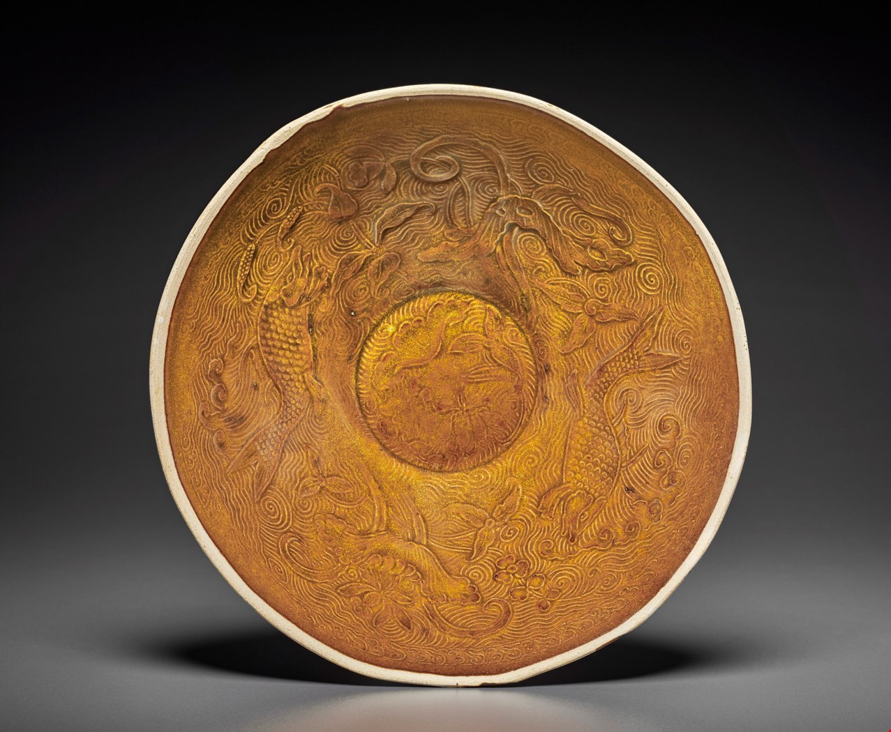 A VERY RARE MOLDED DING-TYPE GOLDEN-BROWN-GLAZED BOWL, LIAO DYNASTY (AD ...